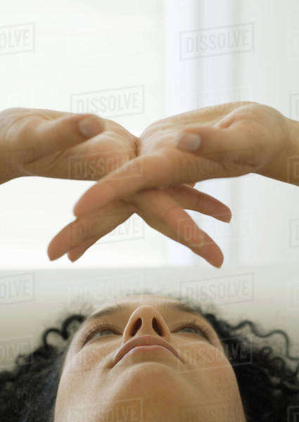 Woman looking at her clasped hands, close-up - Royalty-free Stock Photo ...