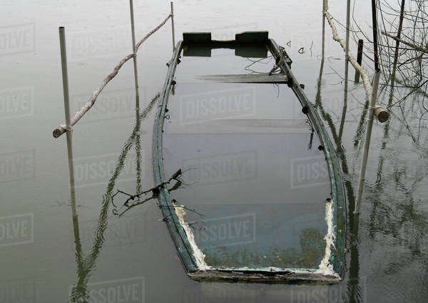 Sunken rowboat in shallow water - Stock Photo - Dissolve