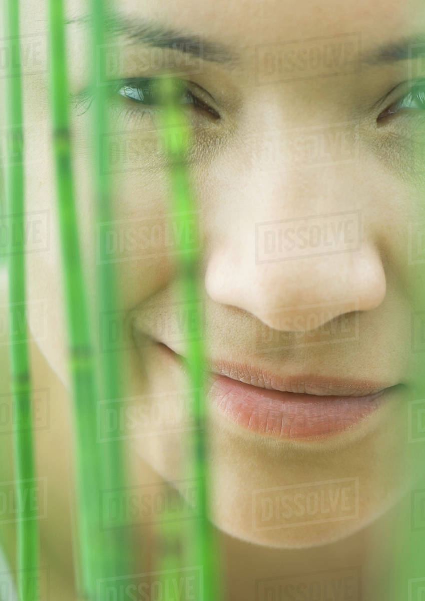 Woman's face, looking through rushes - Royalty-free Stock Photo | Dissolve