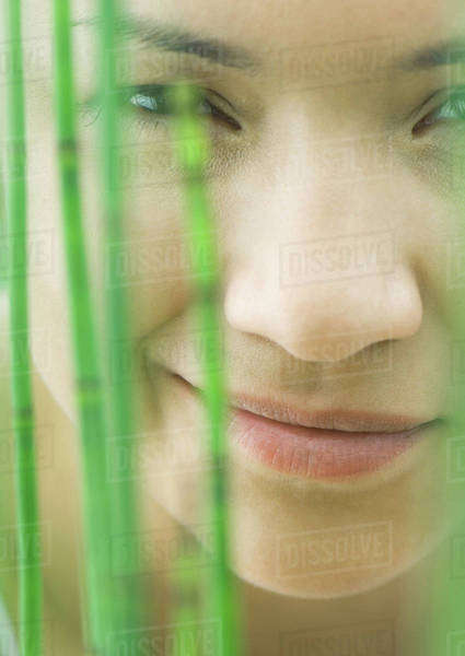 Woman's face, looking through rushes - Royalty-free Stock Photo | Dissolve
