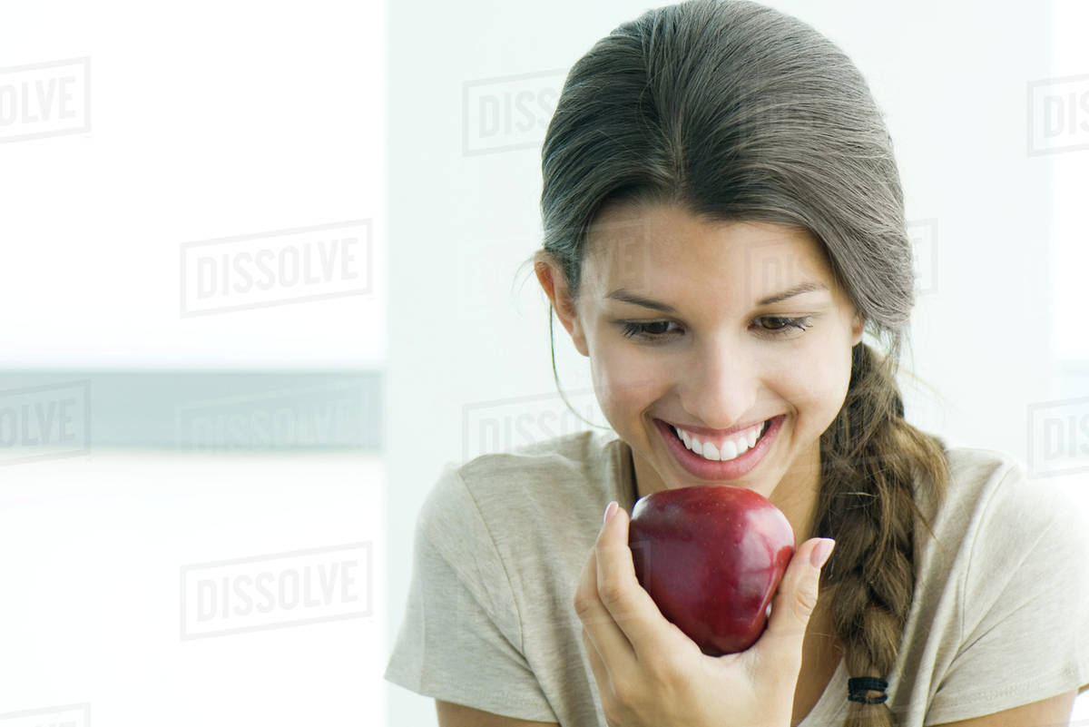 Teen girl eating apple, head and shoulders - Royalty-free Stock Photo ...