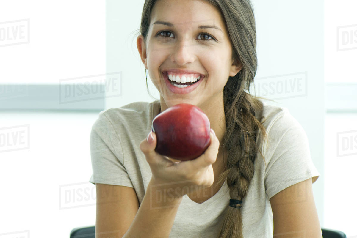 Teen girl holding apple, smiling, portrait - Royalty-free Stock Photo ...