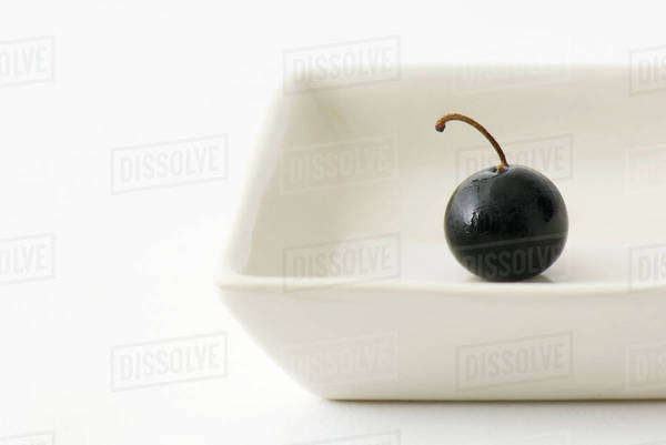 Black currant in dish, close-up - Royalty-free Stock Photo | Dissolve