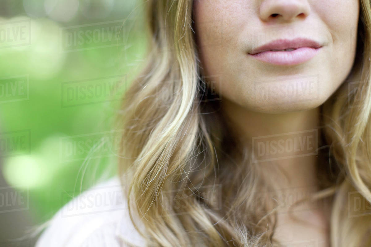 Young woman smiling, cropped - Royalty-free Stock Photo | Dissolve