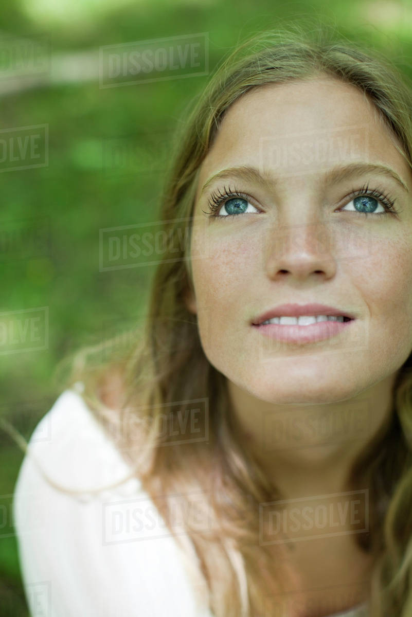 Young woman looking up, portrait - Royalty-free Stock Photo | Dissolve