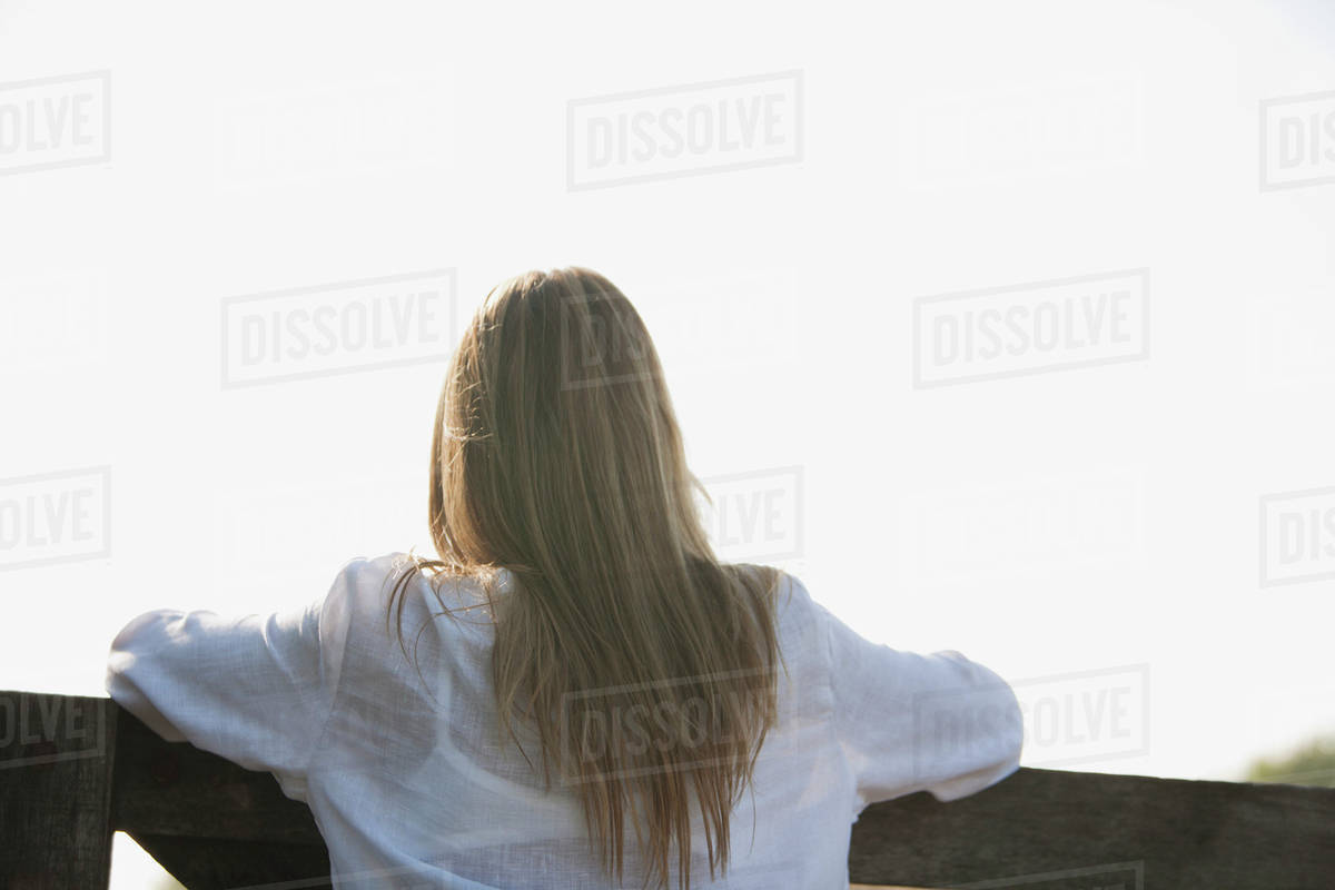 Woman leaning against railing, rear view - Royalty-free Stock Photo ...