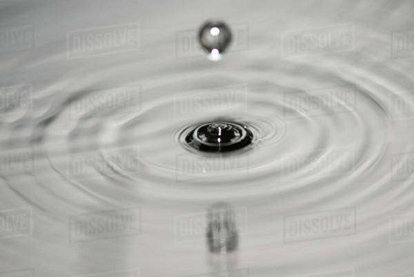 Drop hitting surface of water - Stock Photo - Dissolve