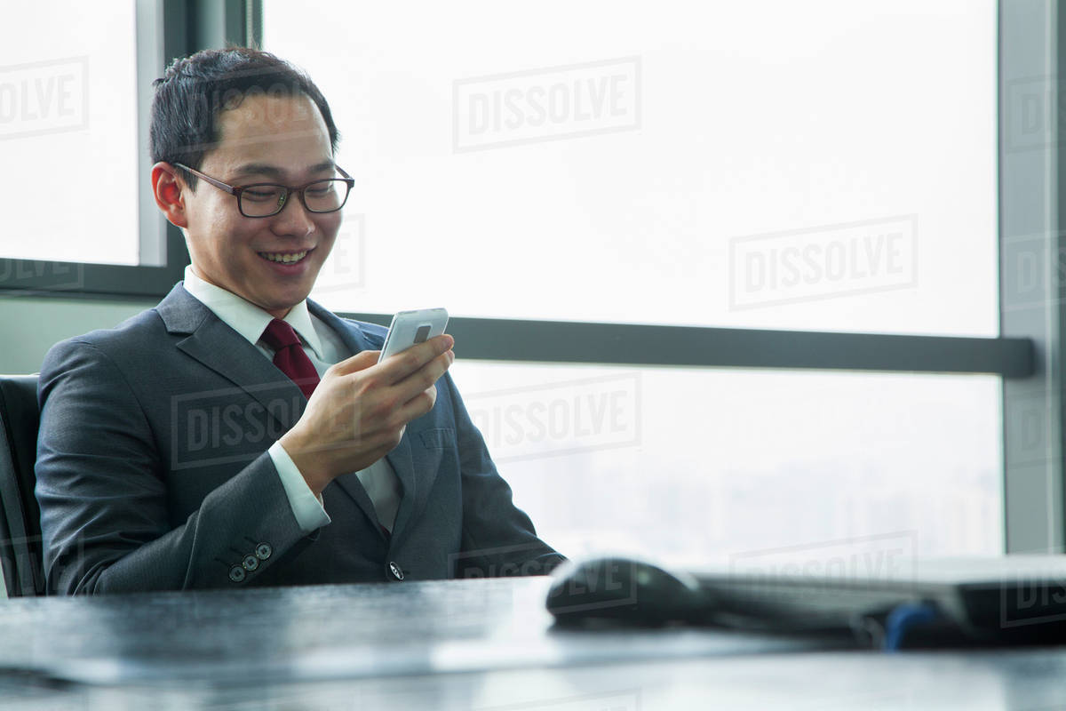 Businessman Using Mobile Phone - Royalty-free Stock Photo | Dissolve