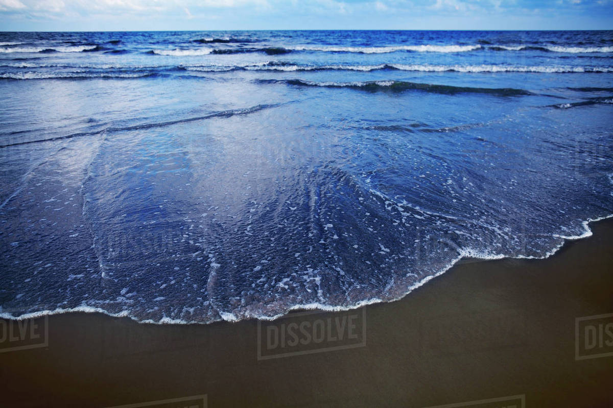 Waves coming into shore at the beach - Royalty-free Stock Photo | Dissolve