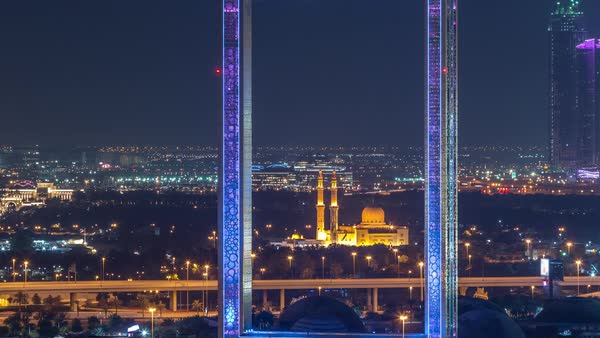 Dubai Frame with Zabeel Masjid mosque illuminated at night timelapse ...
