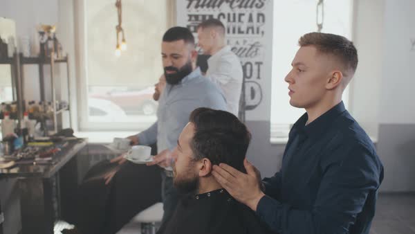Man client talking to hairstylist in modern barber shop. - 4K Royalty ...