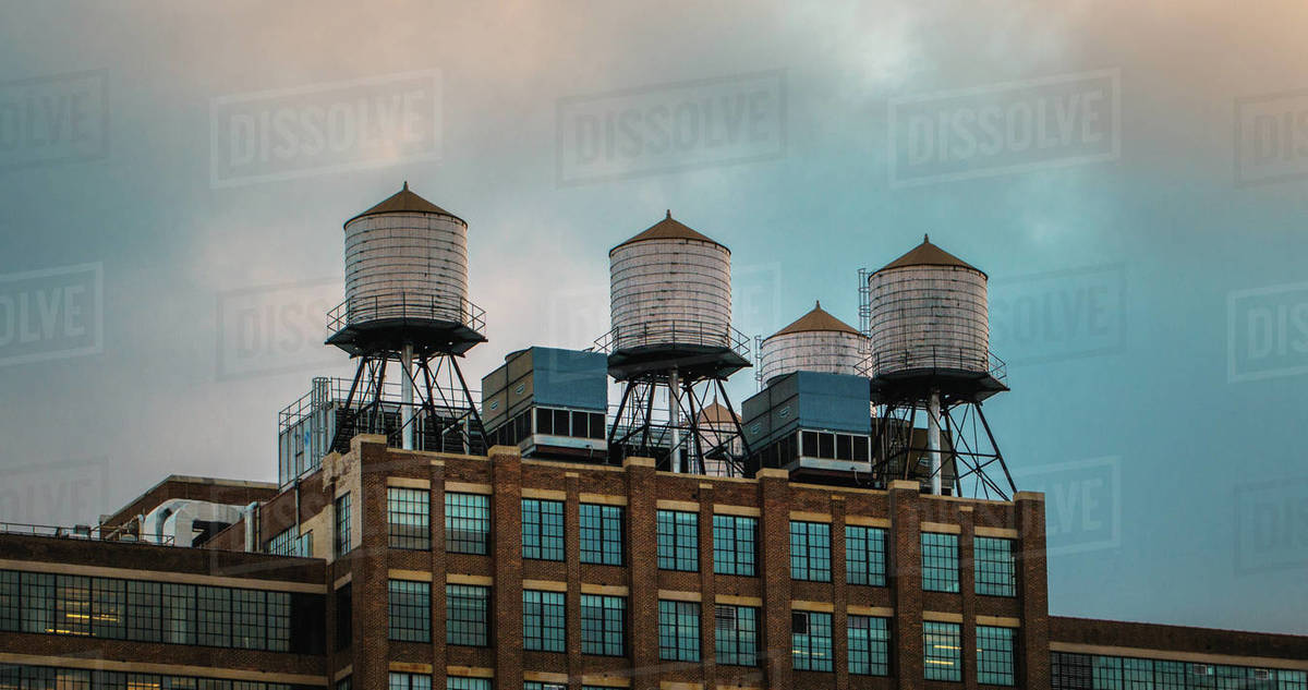 View of rooftop water towers against cloudy sky, New York State, United ...