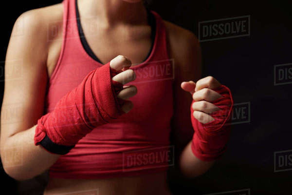 Woman with fists wrapped in preparation for boxing training - Royalty ...