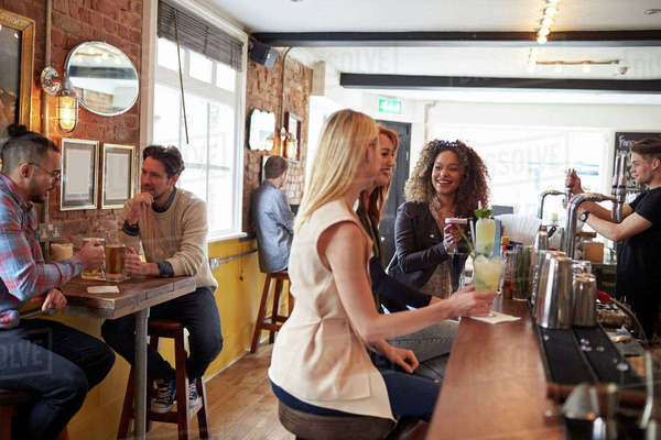 Interior view of busy bar with customers - Stock Photo - Dissolve