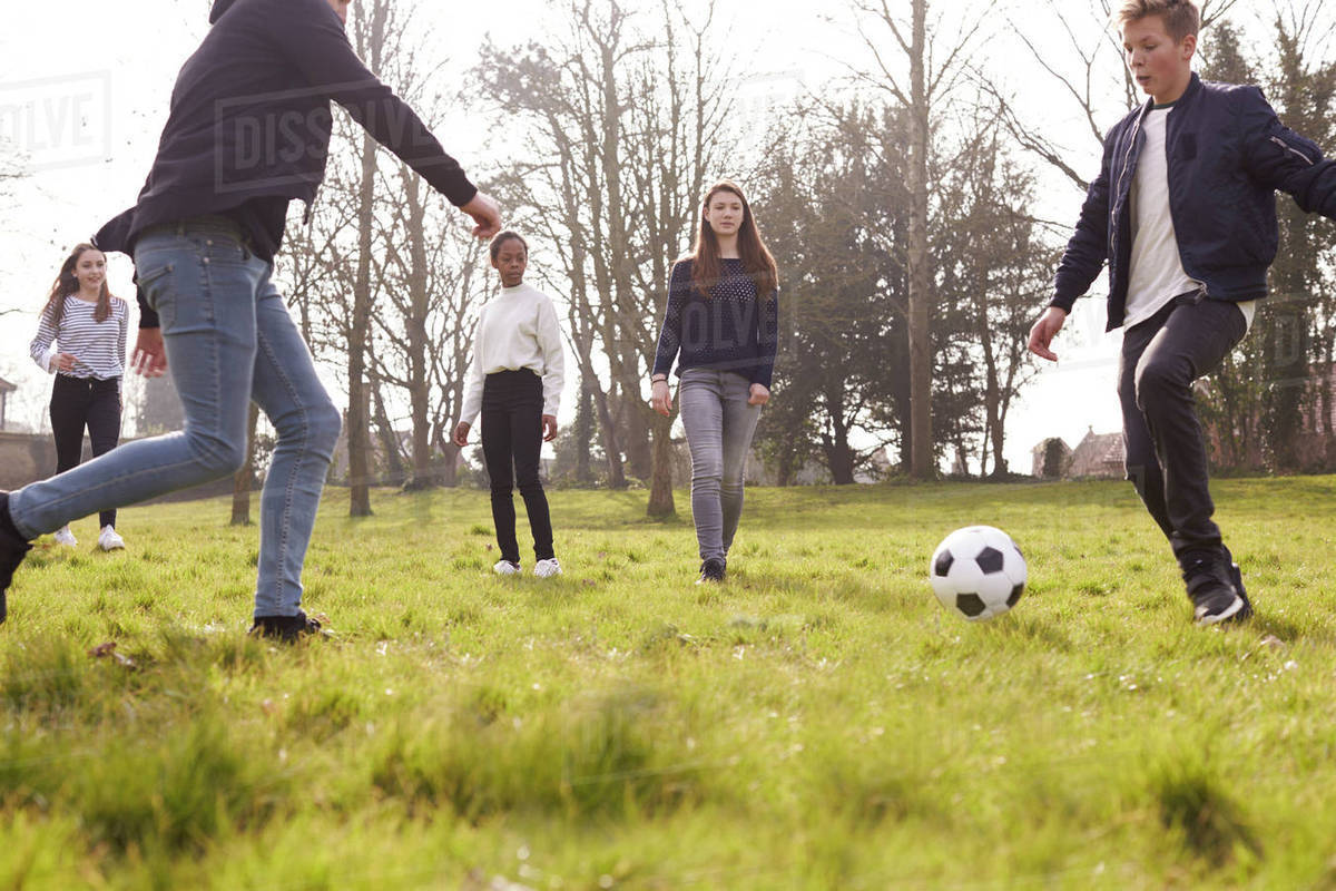 Group of teenagers playing soccer in park together - Royalty-free Stock ...