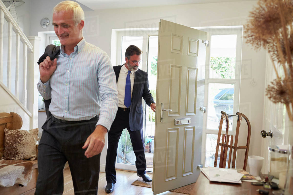 Male couple return home from work, close up - Stock Photo - Dissolve