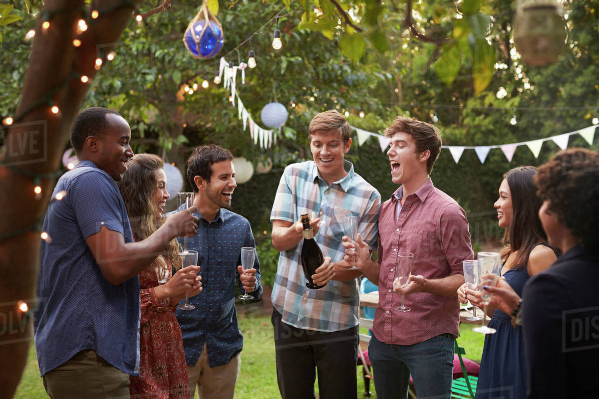 Friends Celebrating With Champagne At Outdoor Backyard Party - Royalty ...