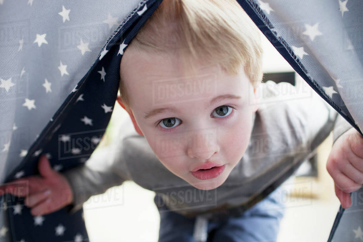 Boy playing inside tent at home - Royalty-free Stock Photo | Dissolve