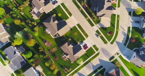 Looking down on beautiful suburban neighborhoods, nice homes, aerial ...