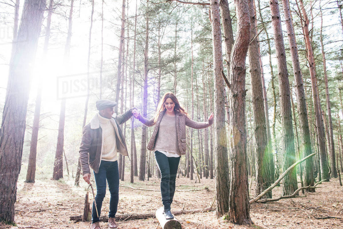 A young couple enjoying a forest walk in Autumn - Stock Photo - Dissolve