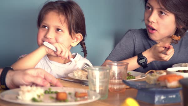 Father and daughter fighting over meatball at the dinner table - 4K ...