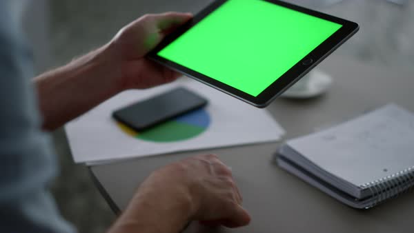 Man hands using tablet device green screen research business finance in ...