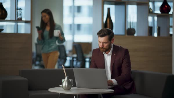 Serious manager working laptop typing keyboard at office hall closeup ...