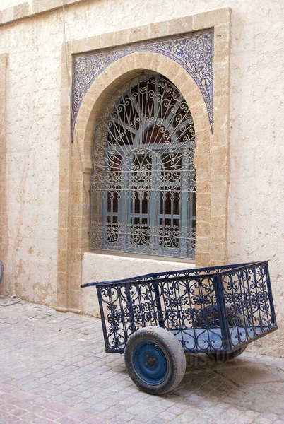 Metal filigree window and cart - Stock Photo - Dissolve