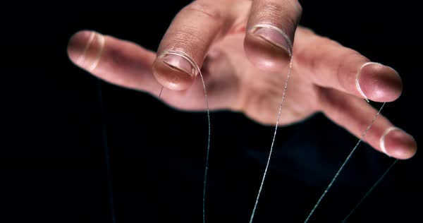 Puppeteer's hand controlling puppet strings - Stock Video Footage ...