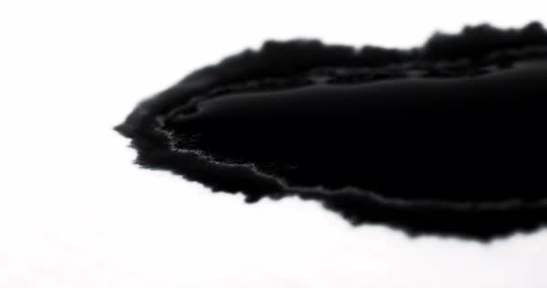Black ink spilling on white paper. Fantastic ink bleeds to use as a ...