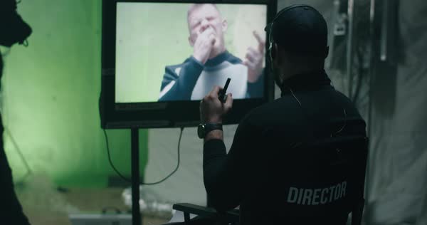 Medium shot of a director giving instructions to the crew during ...