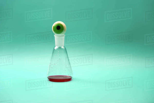 eye prosthesis on top of an Erlenmeyer flask with blood. - Royalty-free ...