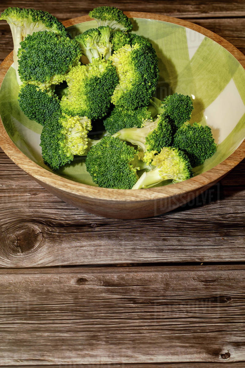 Nutrient rich broccoli green flower buds cut along with stalks placed ...