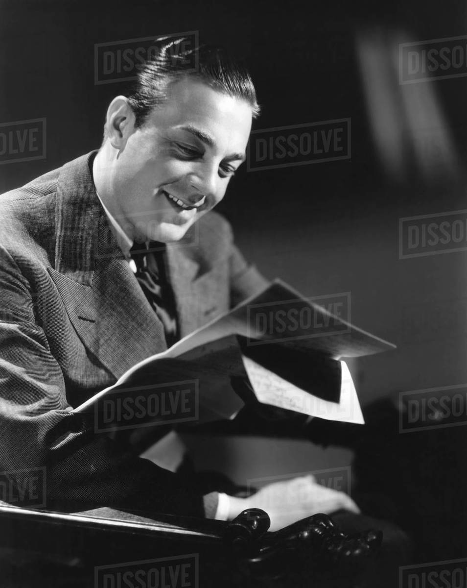 Happy man reading a letter - Stock Photo - Dissolve