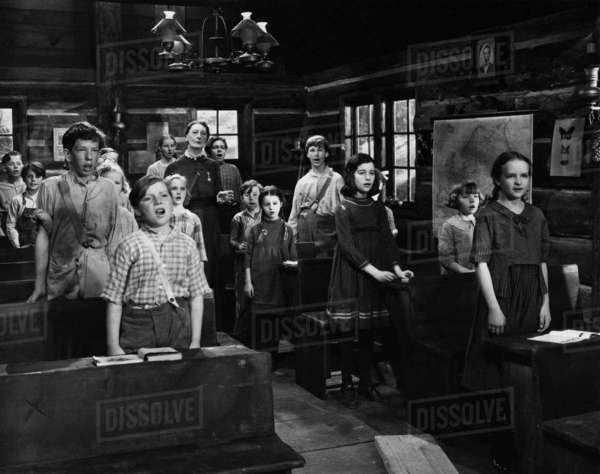 Teacher spanking a girl in a classroom - Stock Photo - Dissolve