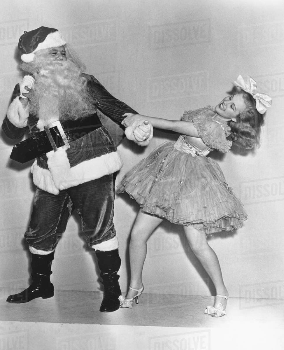 Woman trying to dance with Santa Claus - Royalty-free Stock Photo ...