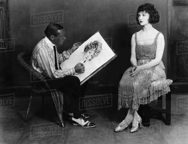 Man drawing portrait of woman - Stock Photo - Dissolve