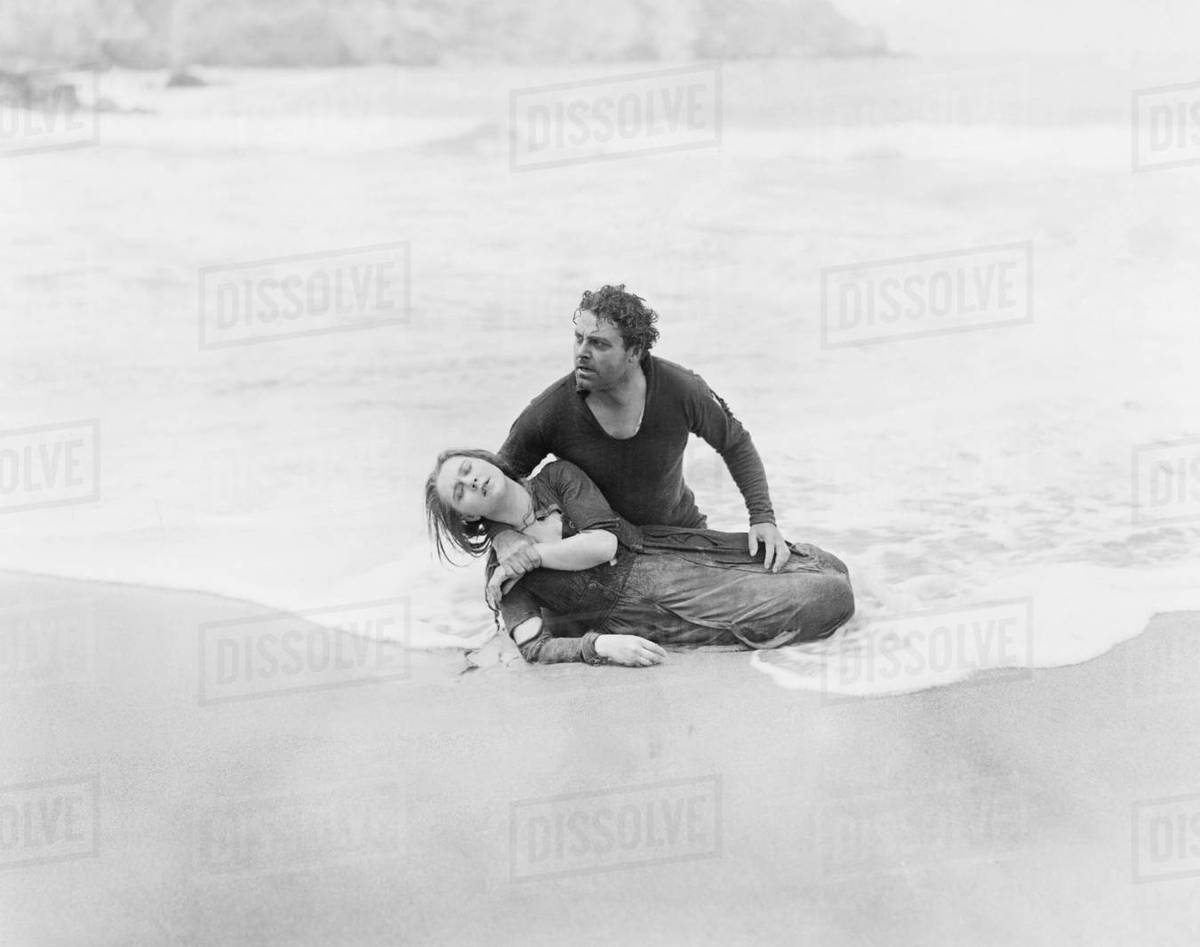 Man rescuing woman from ocean - Stock Photo - Dissolve