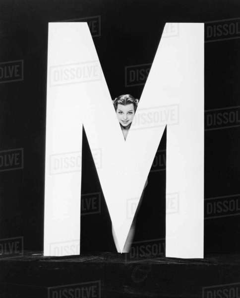 Womans face with huge letter M - Stock Photo - Dissolve