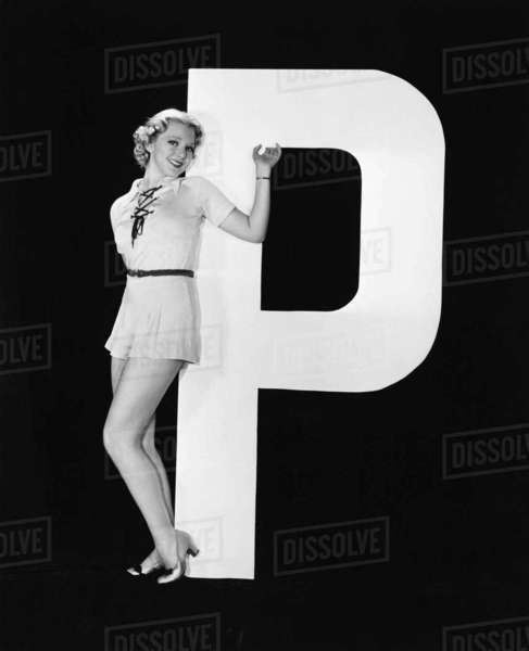 Woman posing with huge letter P - Stock Photo - Dissolve