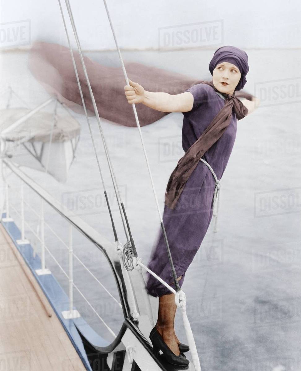 Woman leaning off boat into the wind - Royalty-free Stock Photo | Dissolve