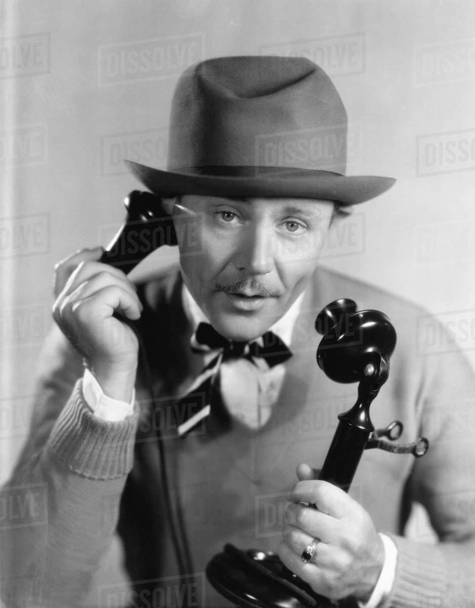 Man in a hat talking on the telephone - Stock Photo - Dissolve