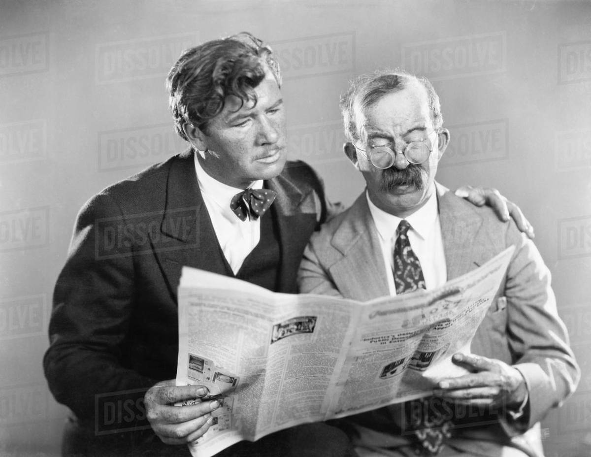 Two mature men reading a newspaper together - Royalty-free Stock Photo ...