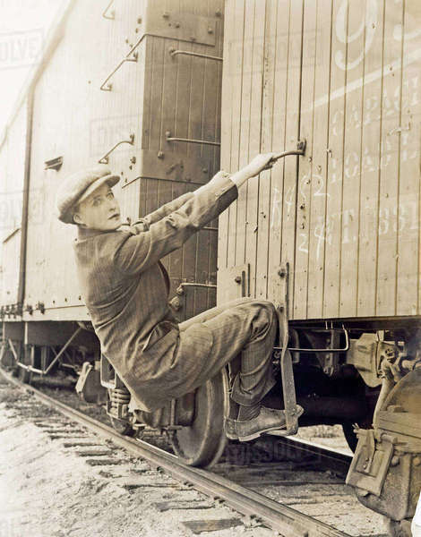 Female hobo climbing freight train - Royalty-free Stock Photo | Dissolve