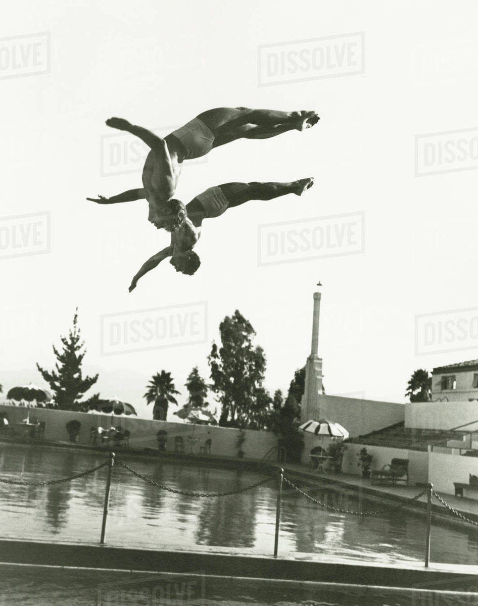 Synchronized divers in mid-air - Stock Photo - Dissolve