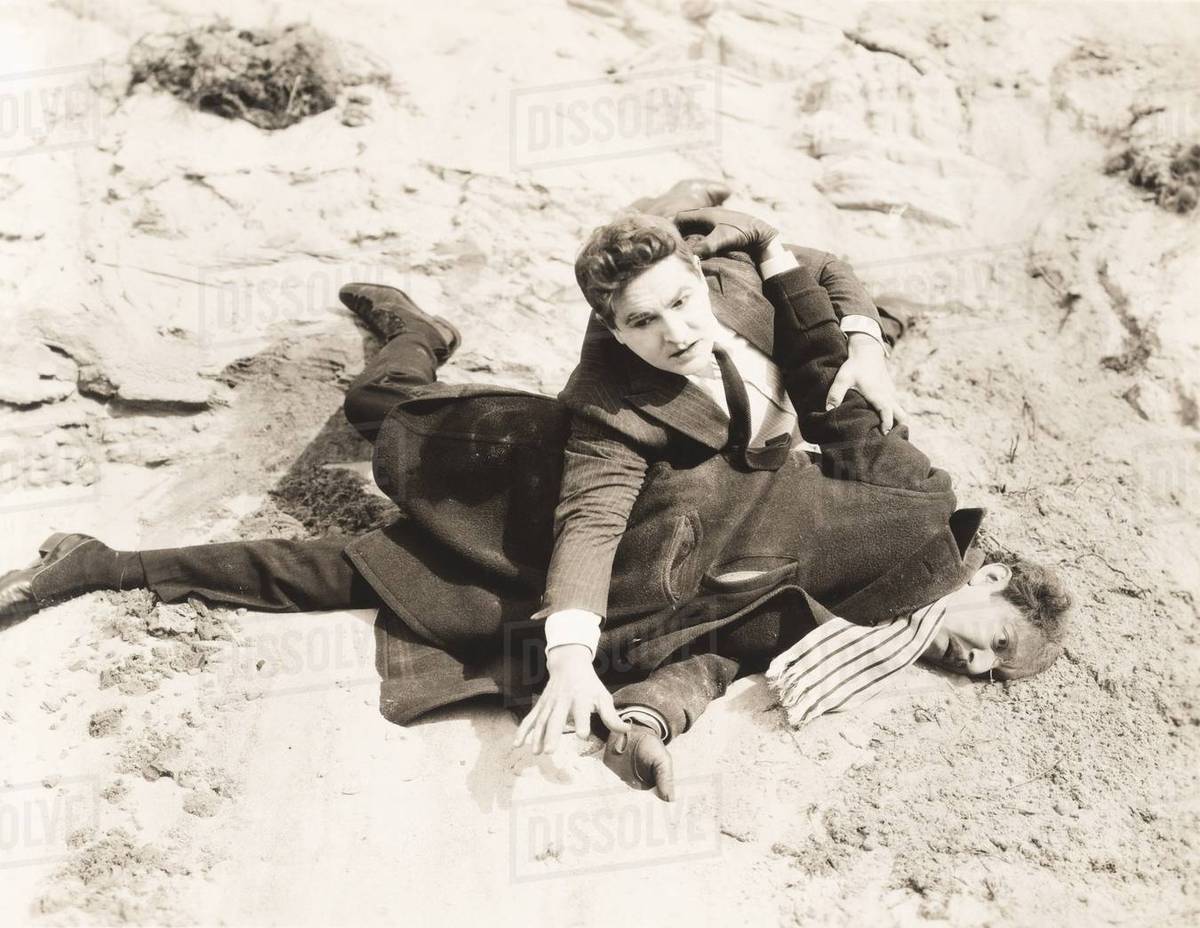 Man pinned to the ground during fight - Royalty-free Stock Photo | Dissolve