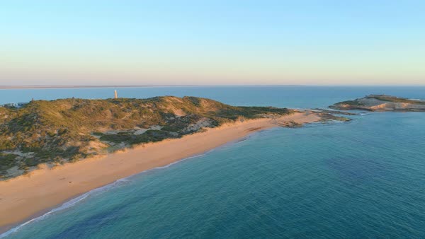 Forward flight along beautiful ocean beach at sunset. Beachport, South ...