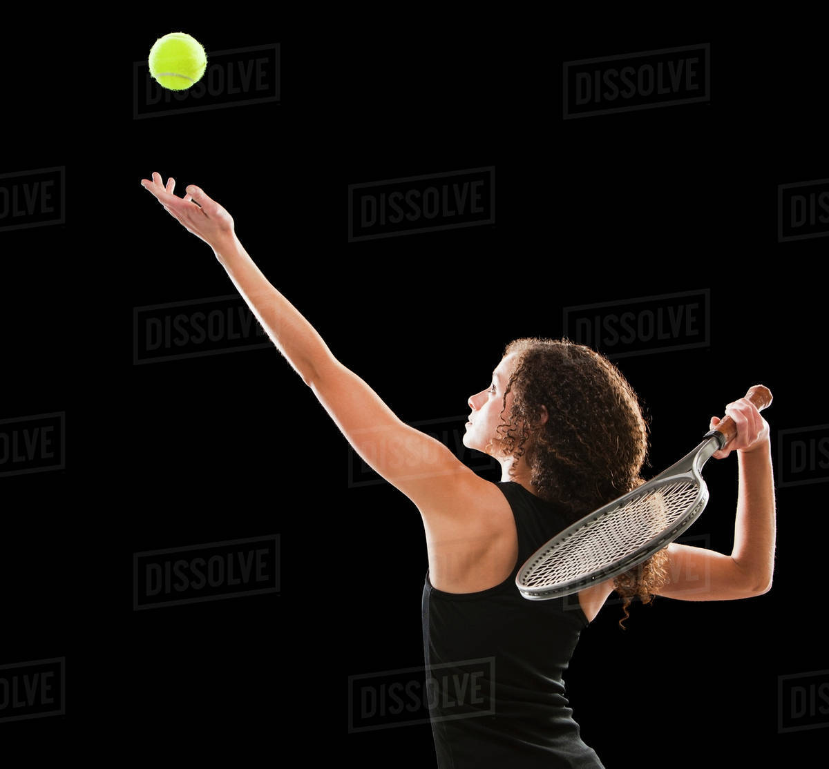Caucasian tennis player serving the ball - Stock Photo - Dissolve