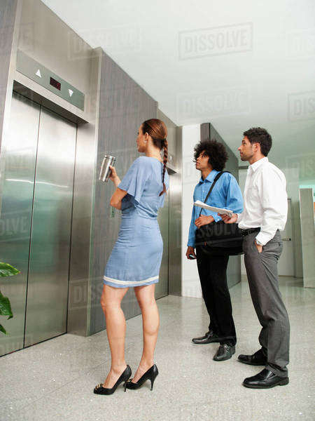 Business people waiting for elevator - Royalty-free Stock Photo | Dissolve