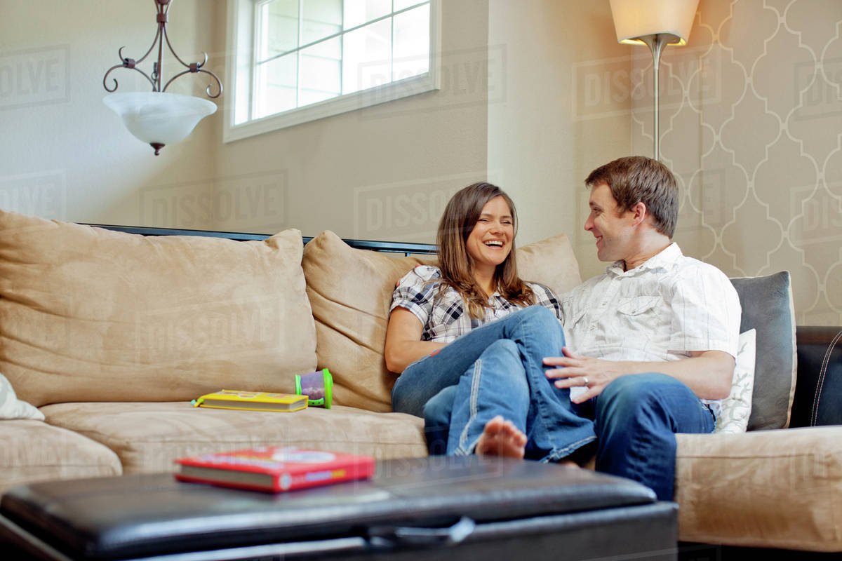 Caucasian couple relaxing in living room - Royalty-free Stock Photo ...